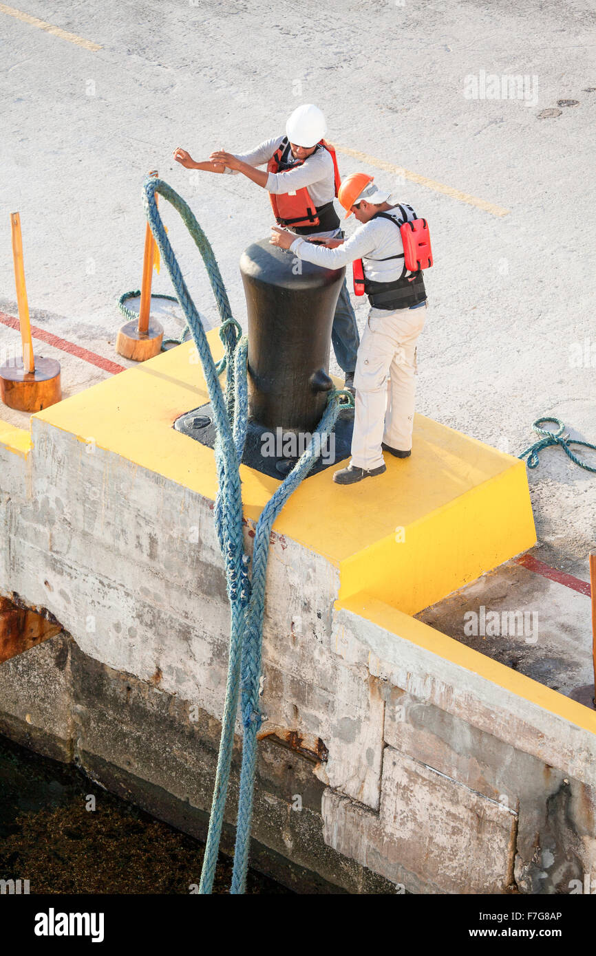Mexican dock workers at the port of Cancun cast off mooring lines as a ...