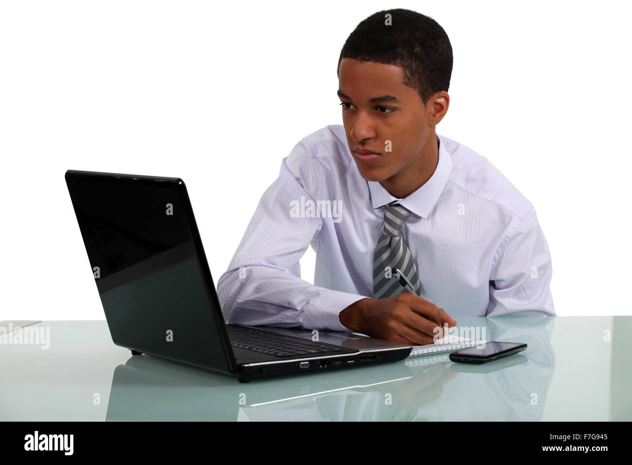Young businessman looking at his laptop Stock Photo - Alamy