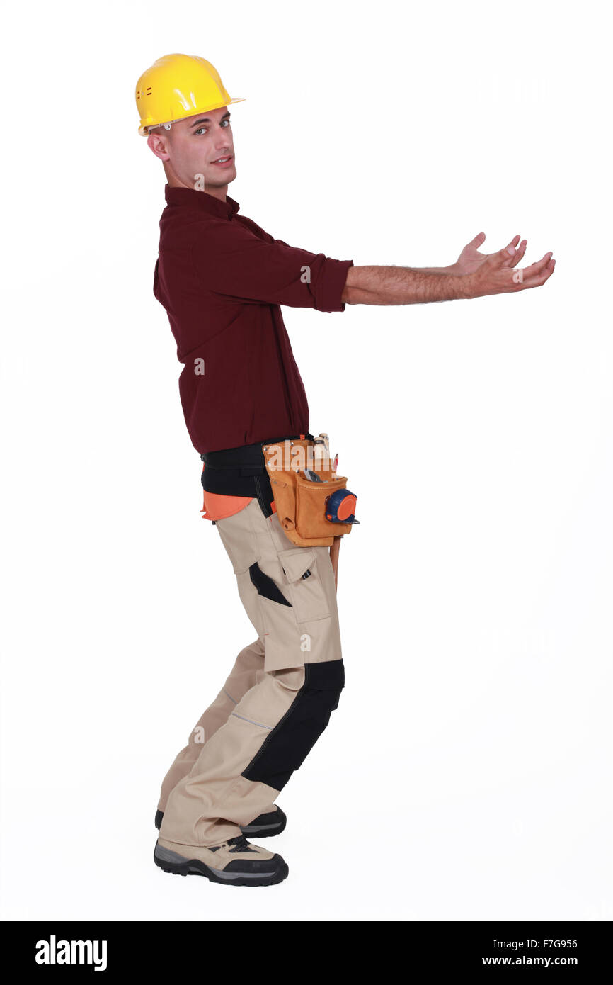 Construction worker holding something heavy Stock Photo - Alamy