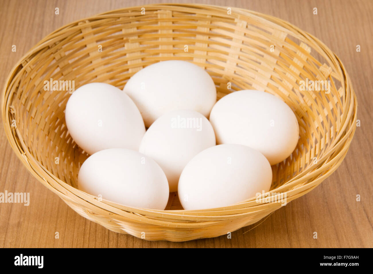 Many white eggs on the wooden table Stock Photo - Alamy