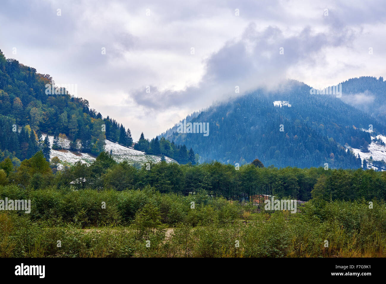 Mountain landscape with clouds snow fog and rain. Alps Stock Photo - Alamy