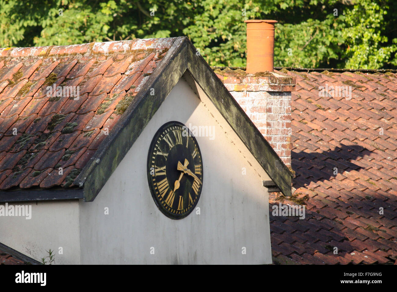 A clock face on an old english barn building Stock Photo - Alamy