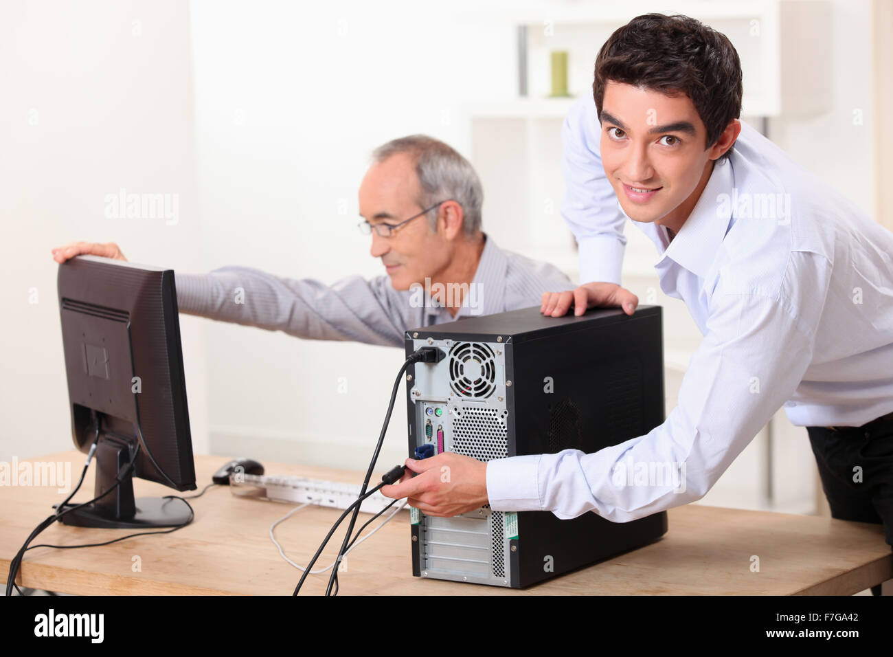 Two men with a computer Stock Photo - Alamy