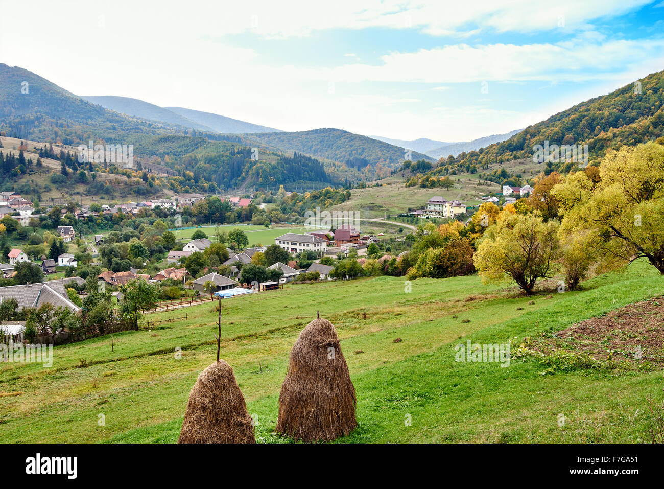 Mountain country village landscape with clouds and blue sky. Alps Stock ...