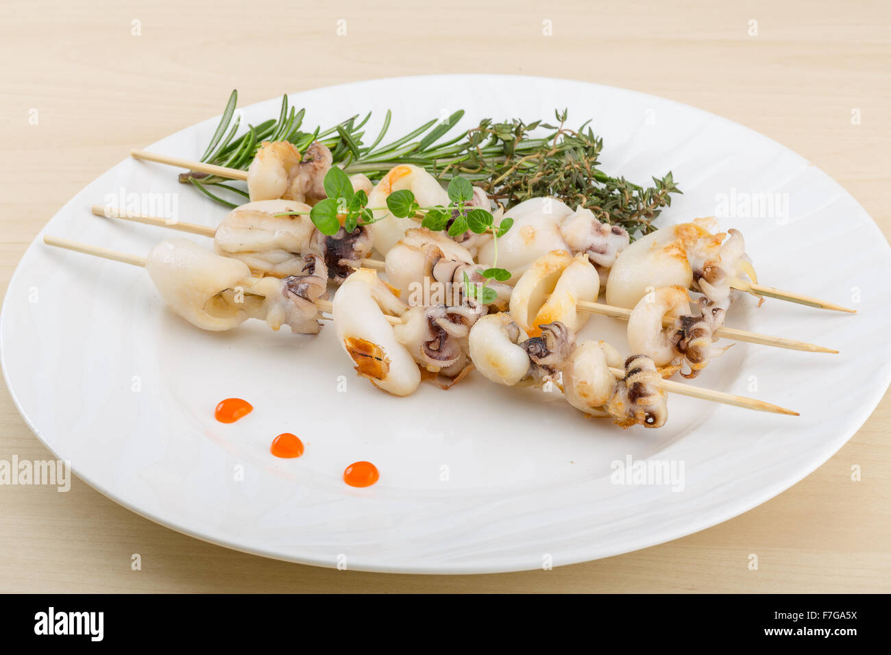 Grilled cuttlefish bbq with rosemary and pepper Stock Photo - Alamy