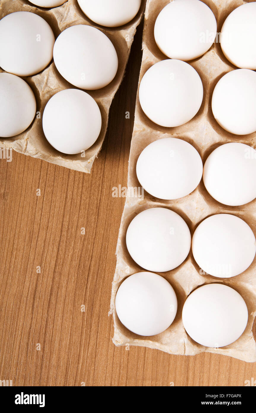 Many white eggs on the wooden table Stock Photo - Alamy