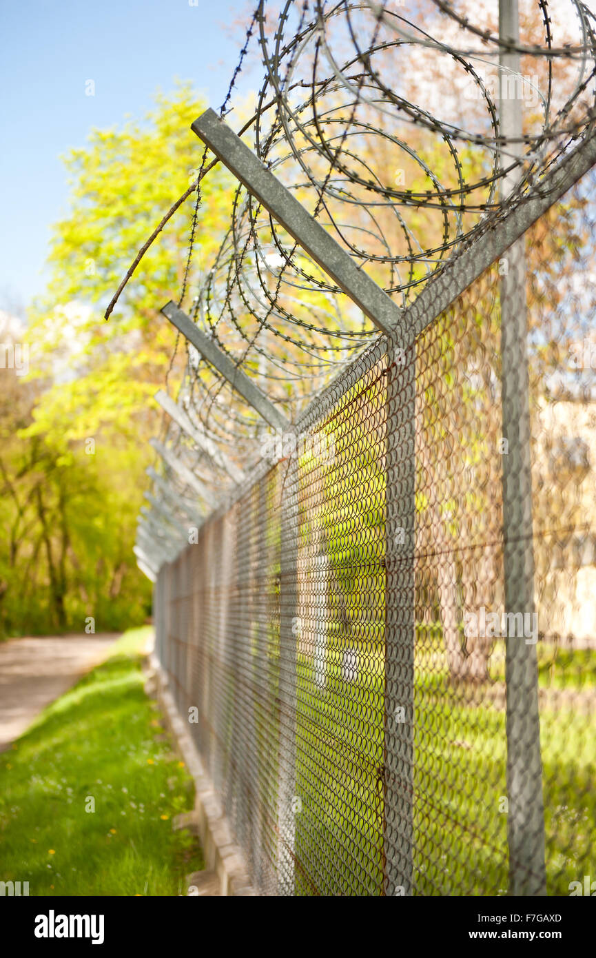 Barbed wire on metal fence, chain link fencing in no trespassing area ...
