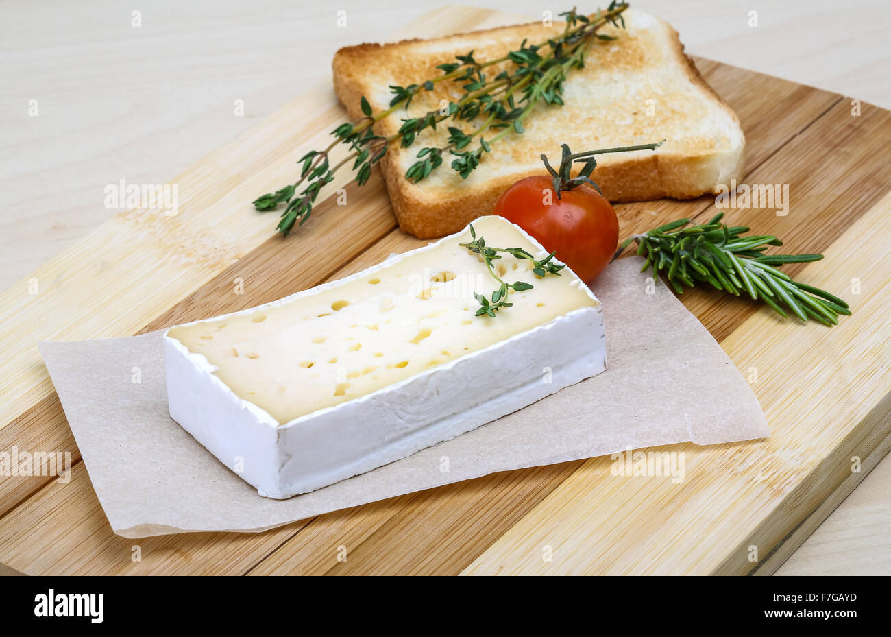 Soft brie cheese with rosemary, thyme and toast bread Stock Photo - Alamy