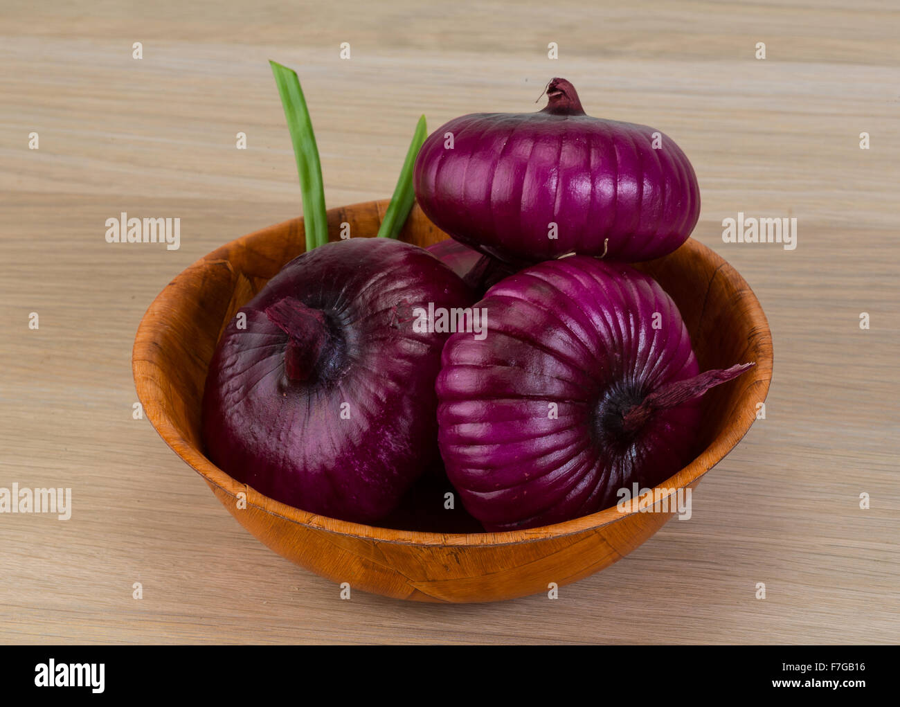 Violet onion in the basket with green Stock Photo - Alamy