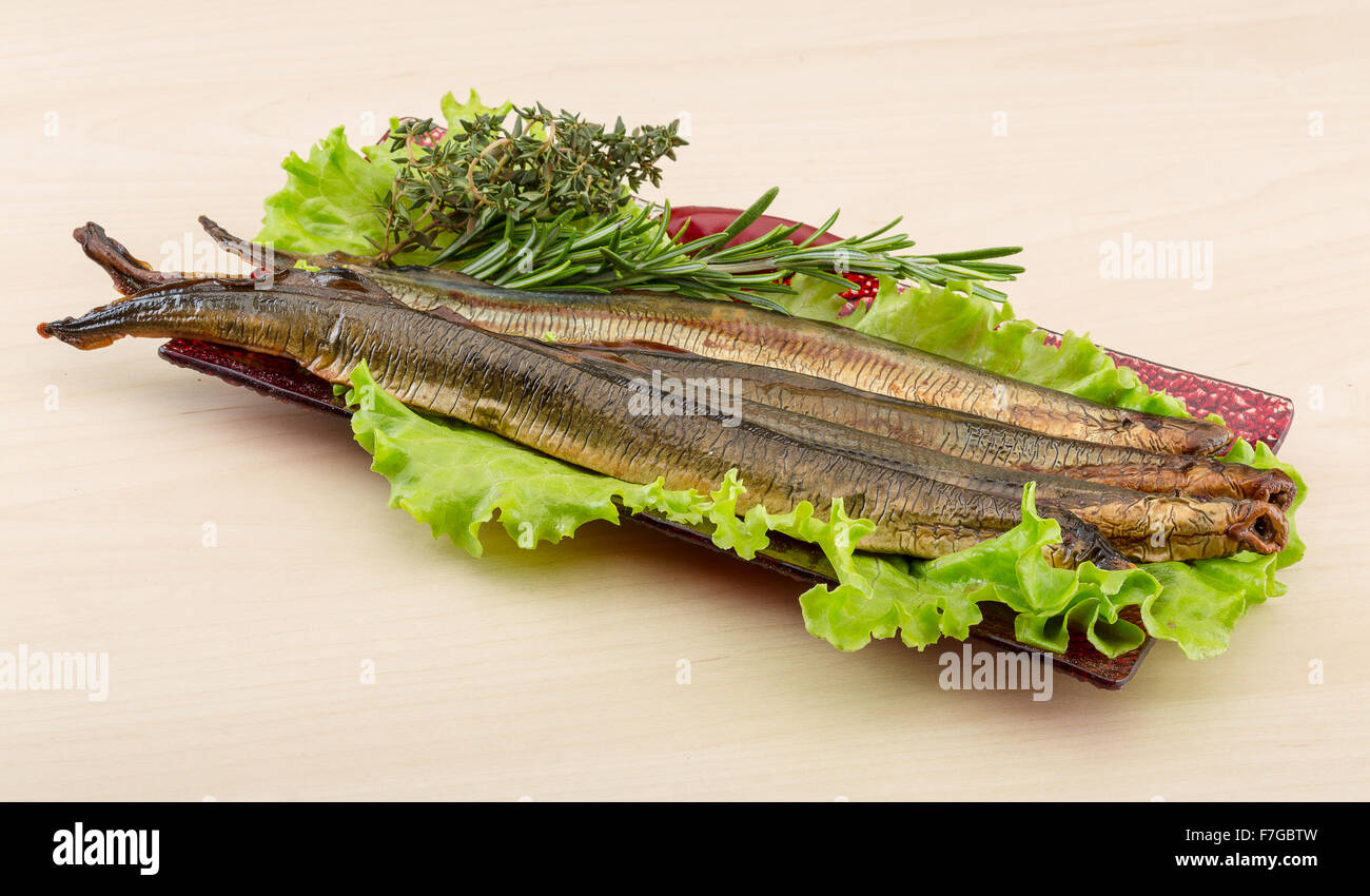 Smoked Lamprey - seafood delicacy with salad and herbs Stock Photo - Alamy