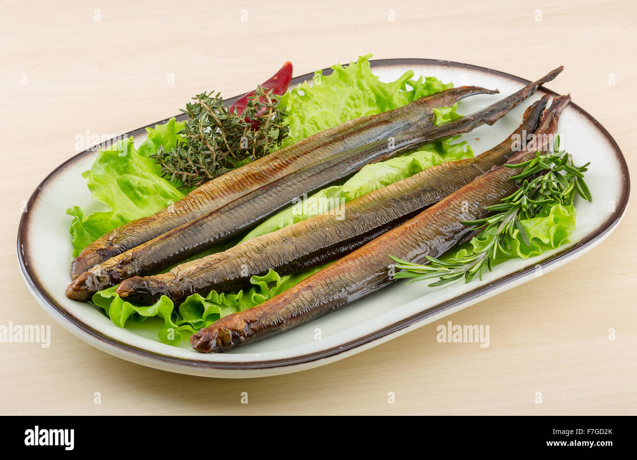 Smoked Lamprey - seafood delicacy with salad and herbs Stock Photo - Alamy