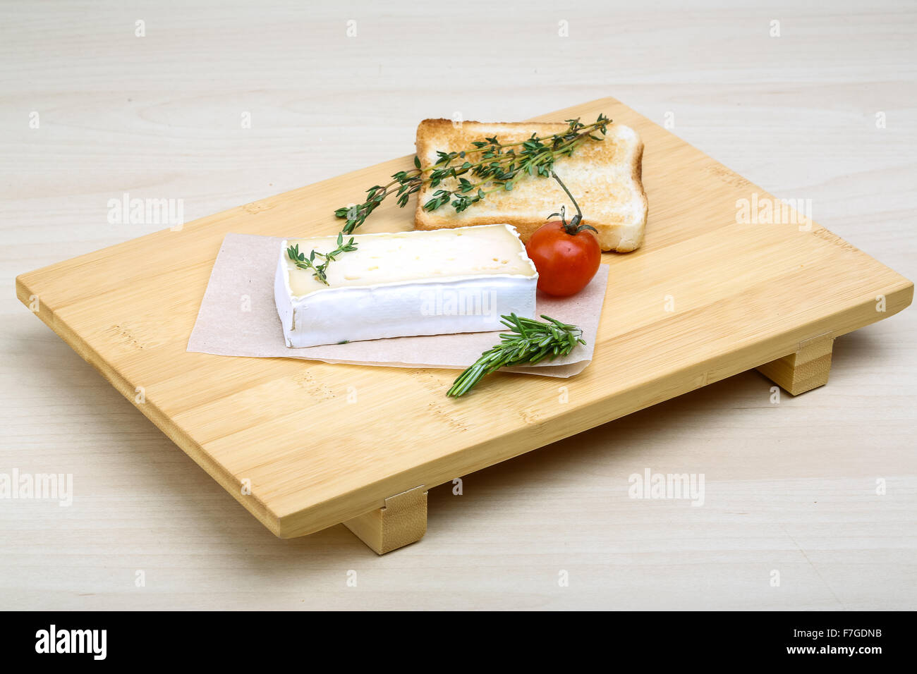 Soft brie cheese with rosemary, thyme and toast bread Stock Photo - Alamy