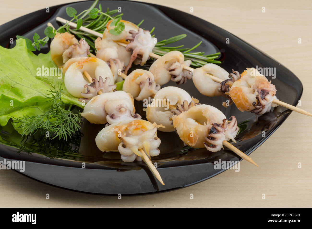 Grilled cuttlefish bbq with rosemary and pepper Stock Photo - Alamy