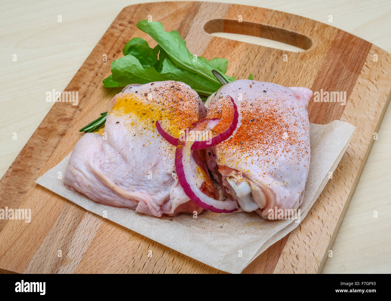 Two Raw chicken thights with herbs and spices Stock Photo - Alamy