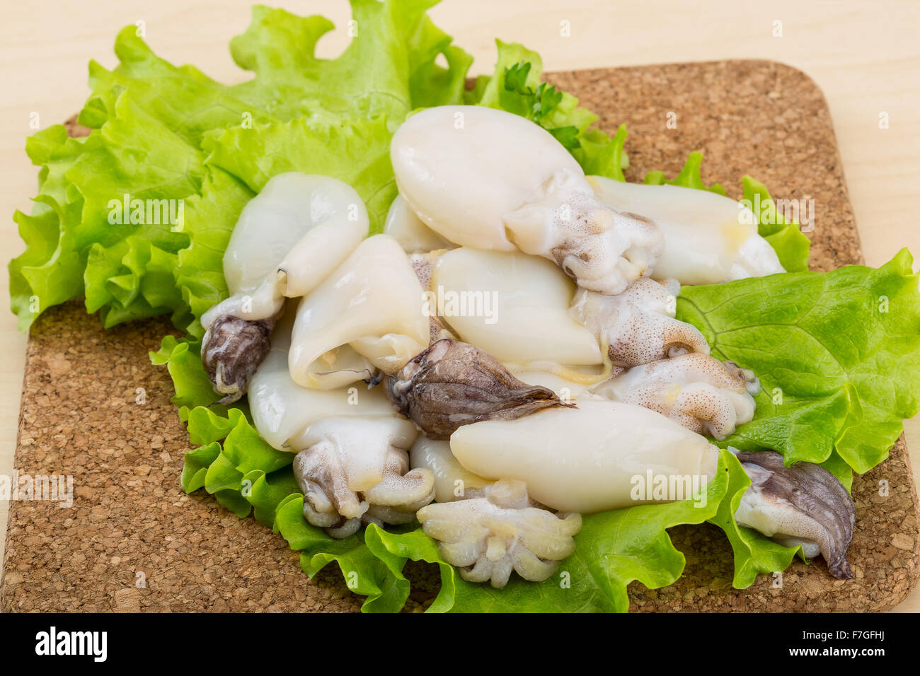 Raw cuttlefish with herbs on the wood background Stock Photo - Alamy