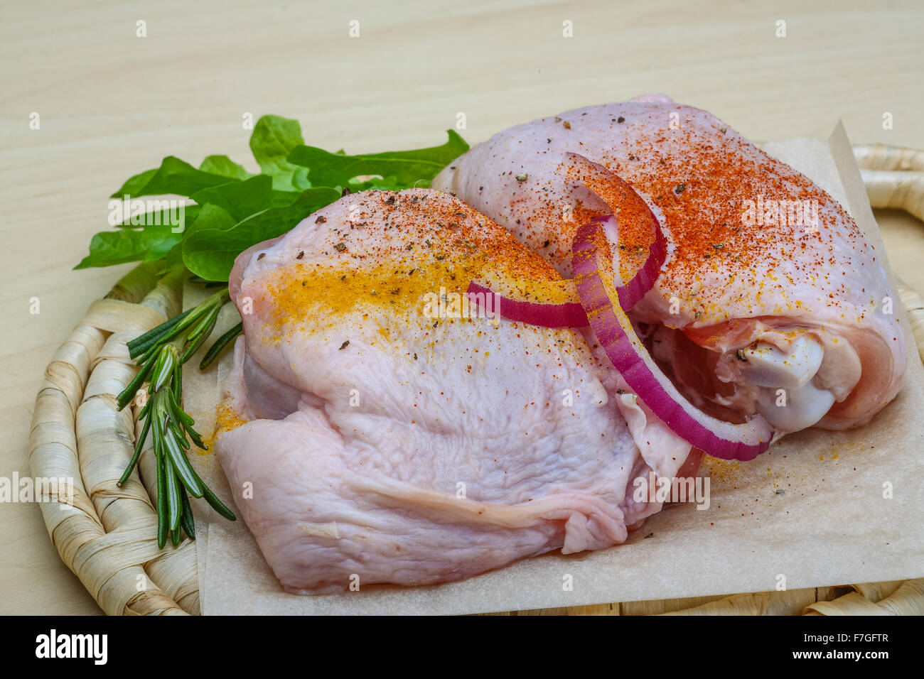 Two Raw chicken thights with herbs and spices Stock Photo - Alamy