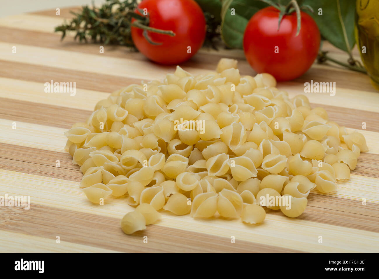 Raw Shell pasta on the wood background Stock Photo - Alamy