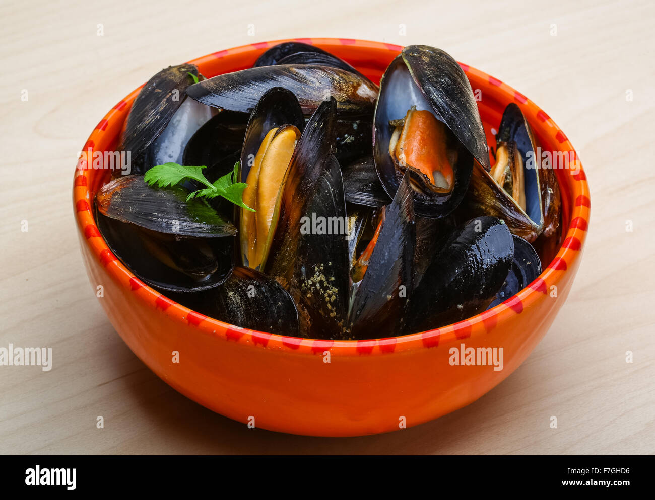 Fresh tasty Boiled mussels with herbs on wood background Stock Photo ...