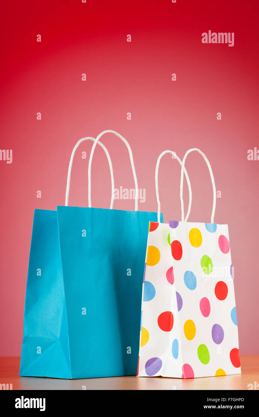 Colourful paper shopping bags against gradient background Stock Photo ...