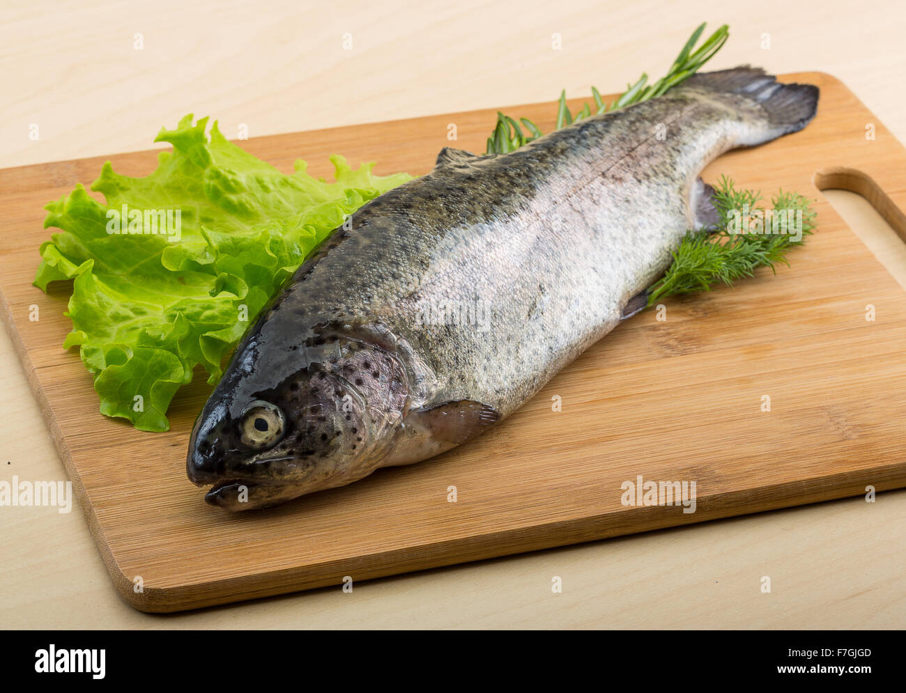 Raw fresh trout on the wood background with herbs Stock Photo - Alamy
