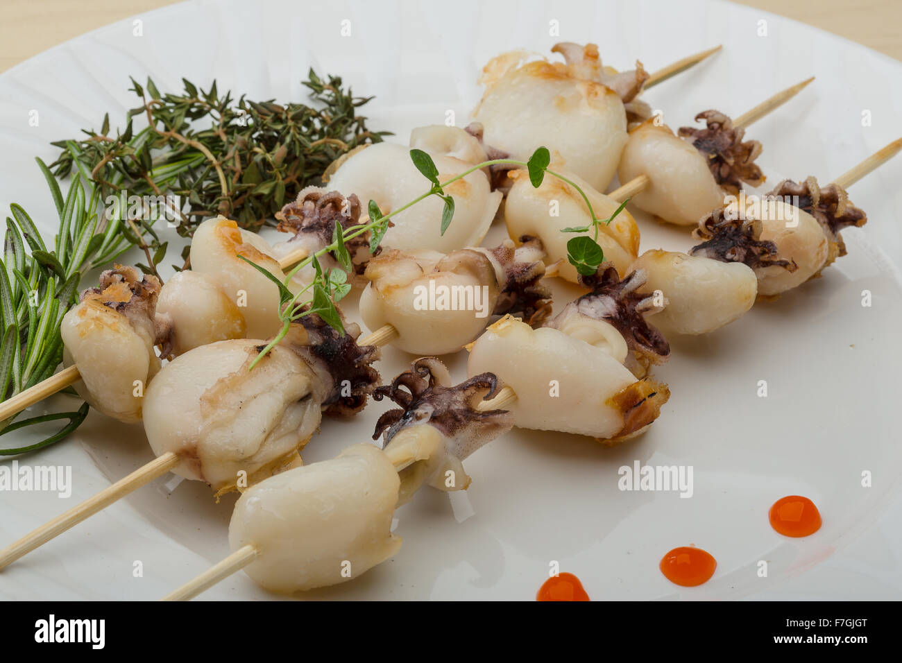 Grilled cuttlefish bbq with rosemary and pepper Stock Photo - Alamy