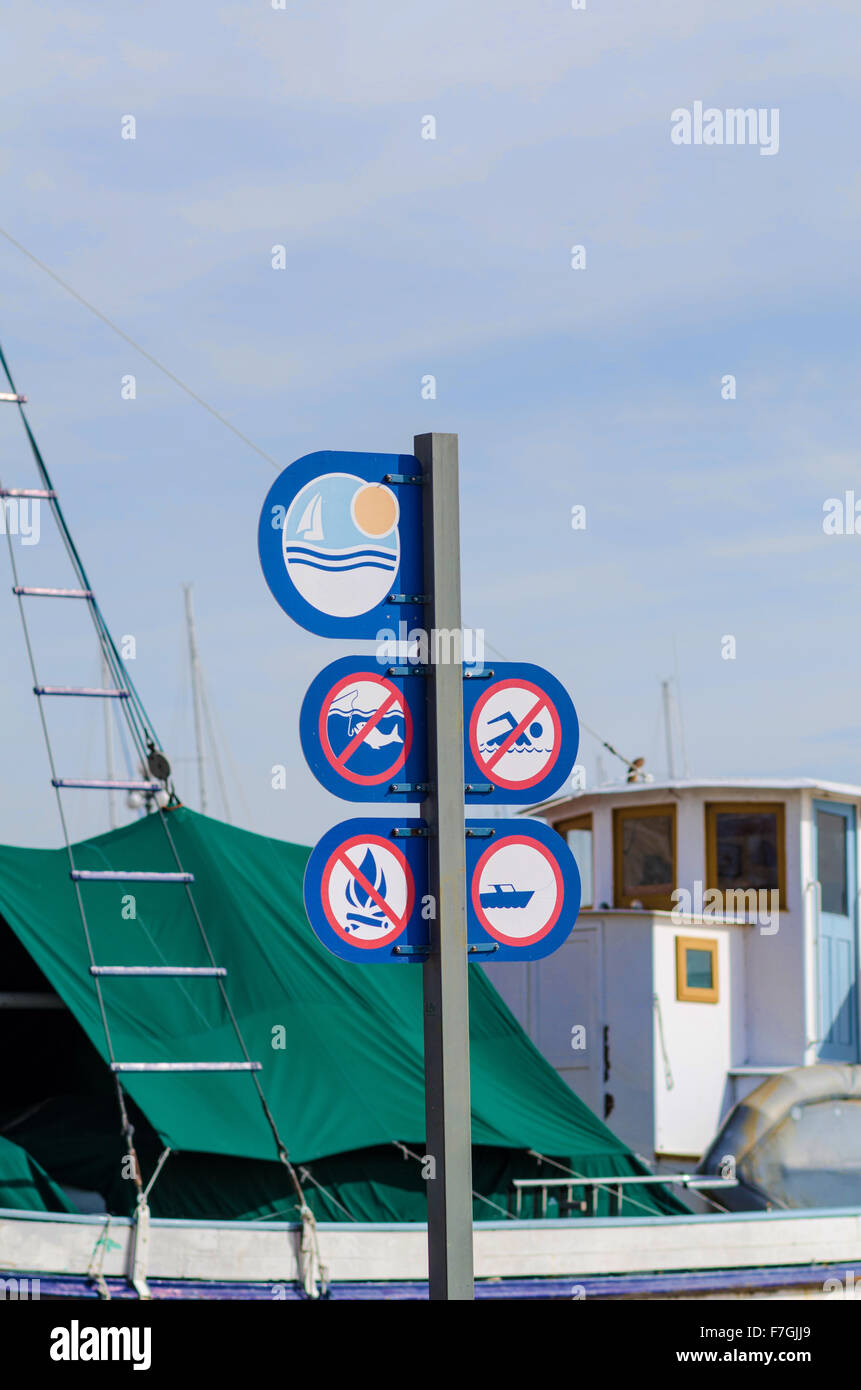 Signpost with safety instructions on a harbor pier Stock Photo - Alamy