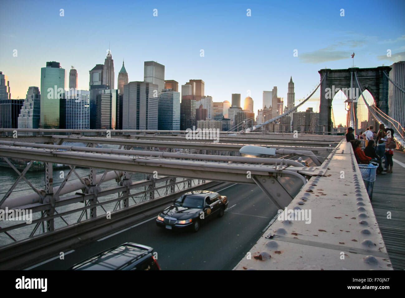 NEW YORK - JUN 25: Local people, tourists and cars on Brooklyn bridge ...