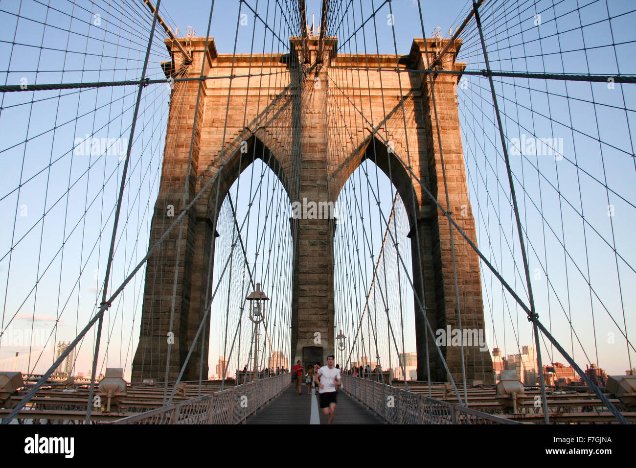 NEW YORK - JUN 25: Local people and tourists walking Brooklyn bridge ...