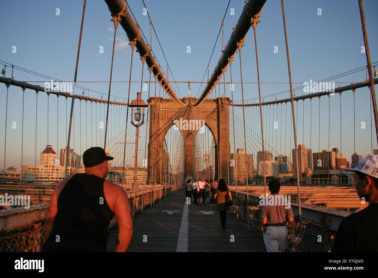 NEW YORK - JUN 25: Local people, tourists and cars on Brooklyn bridge ...