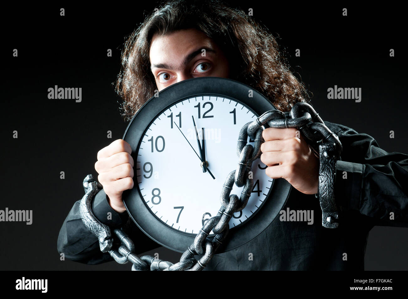 Man chained to the clock Stock Photo - Alamy
