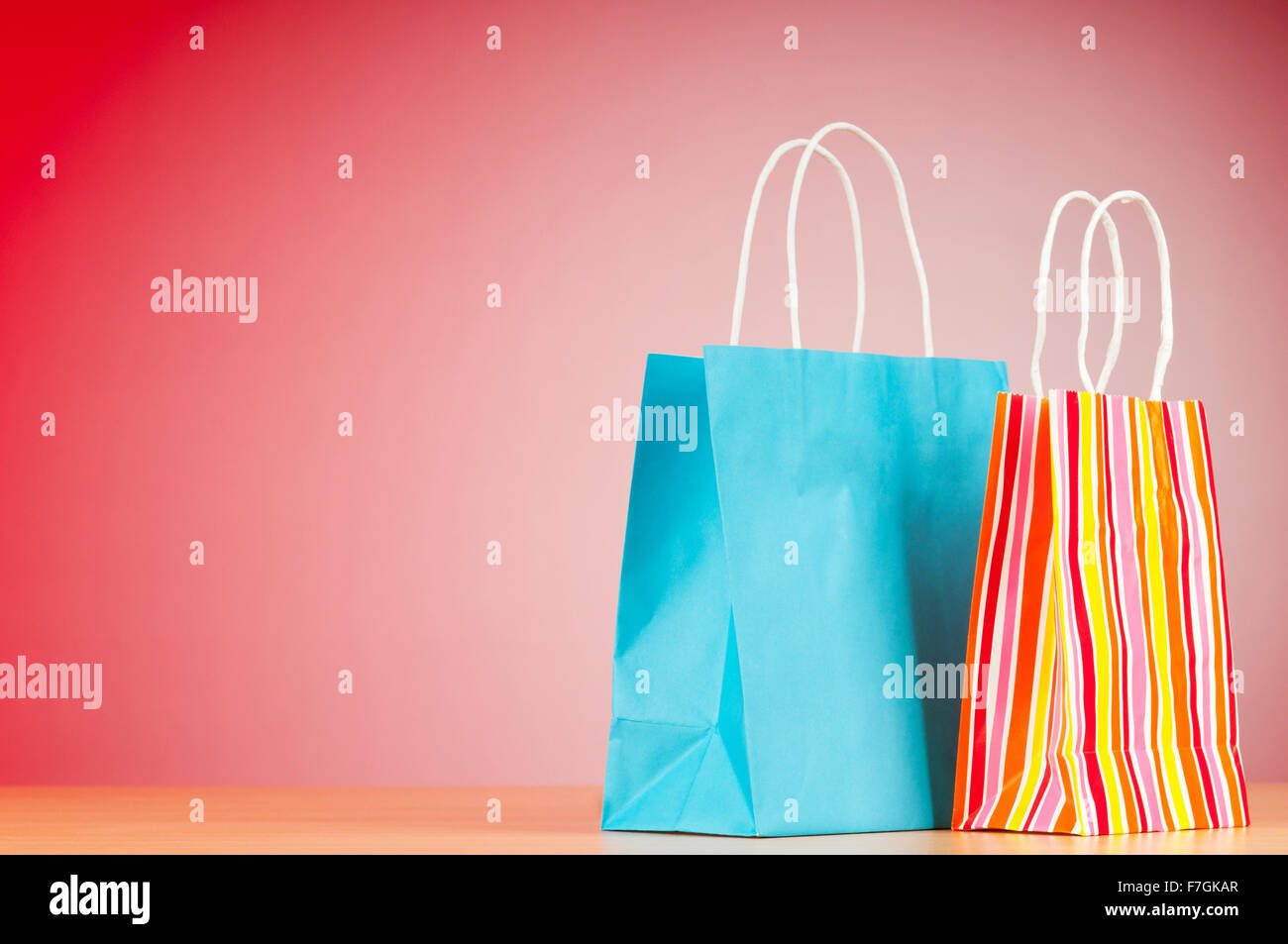 Colourful paper shopping bags against gradient background Stock Photo ...