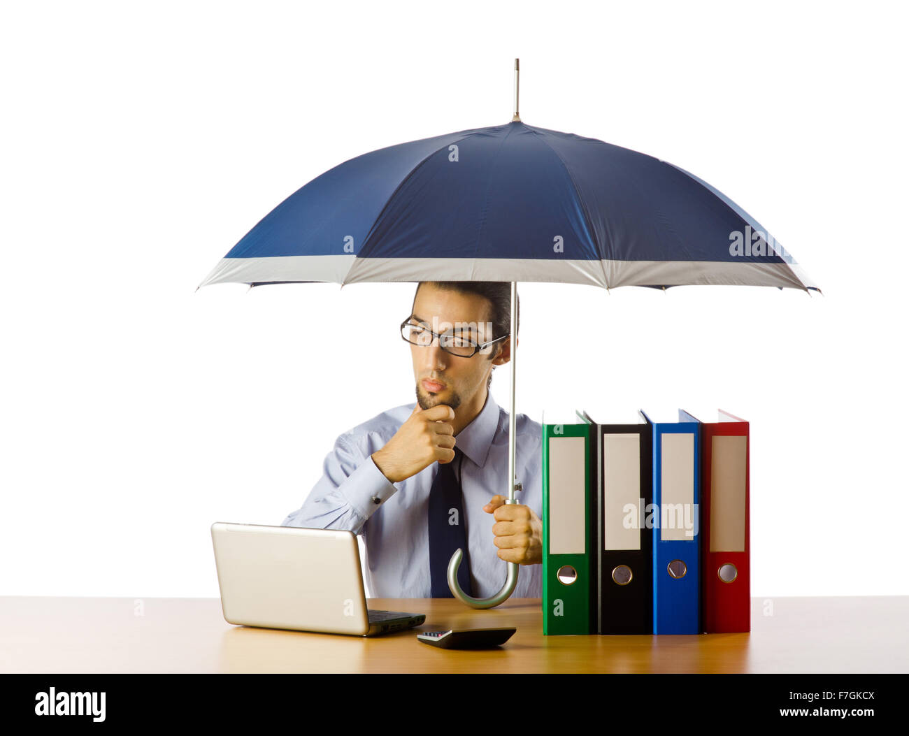 Businessman holding umbrella in the office Stock Photo - Alamy