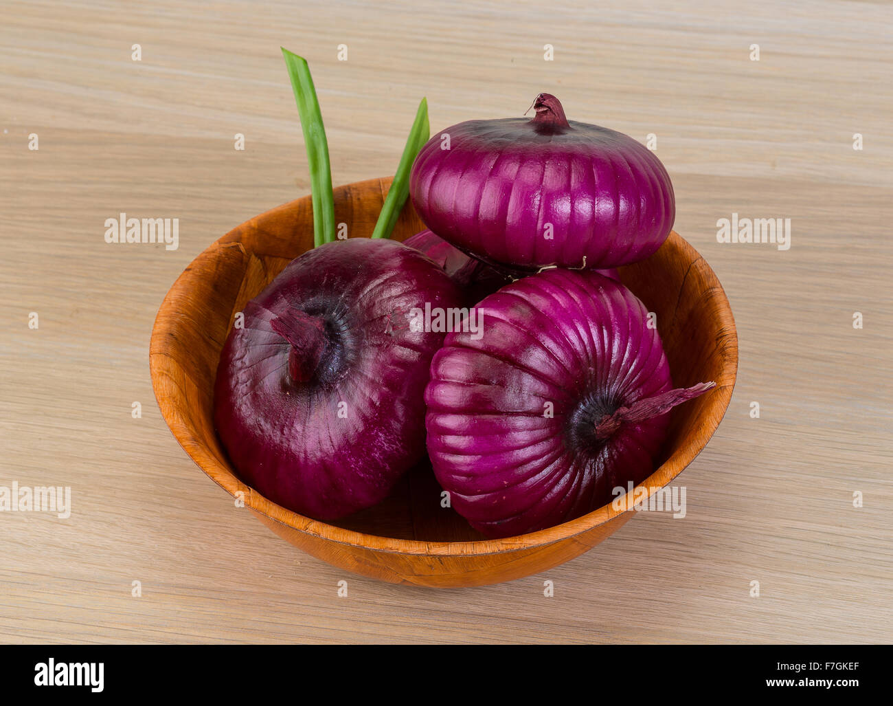Violet onion in the basket with green Stock Photo - Alamy