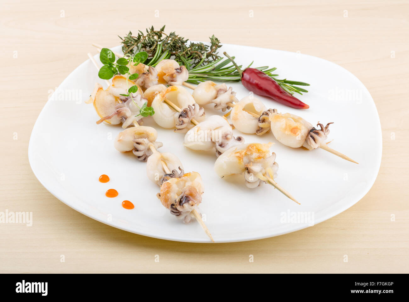 Grilled cuttlefish bbq with rosemary and pepper Stock Photo - Alamy