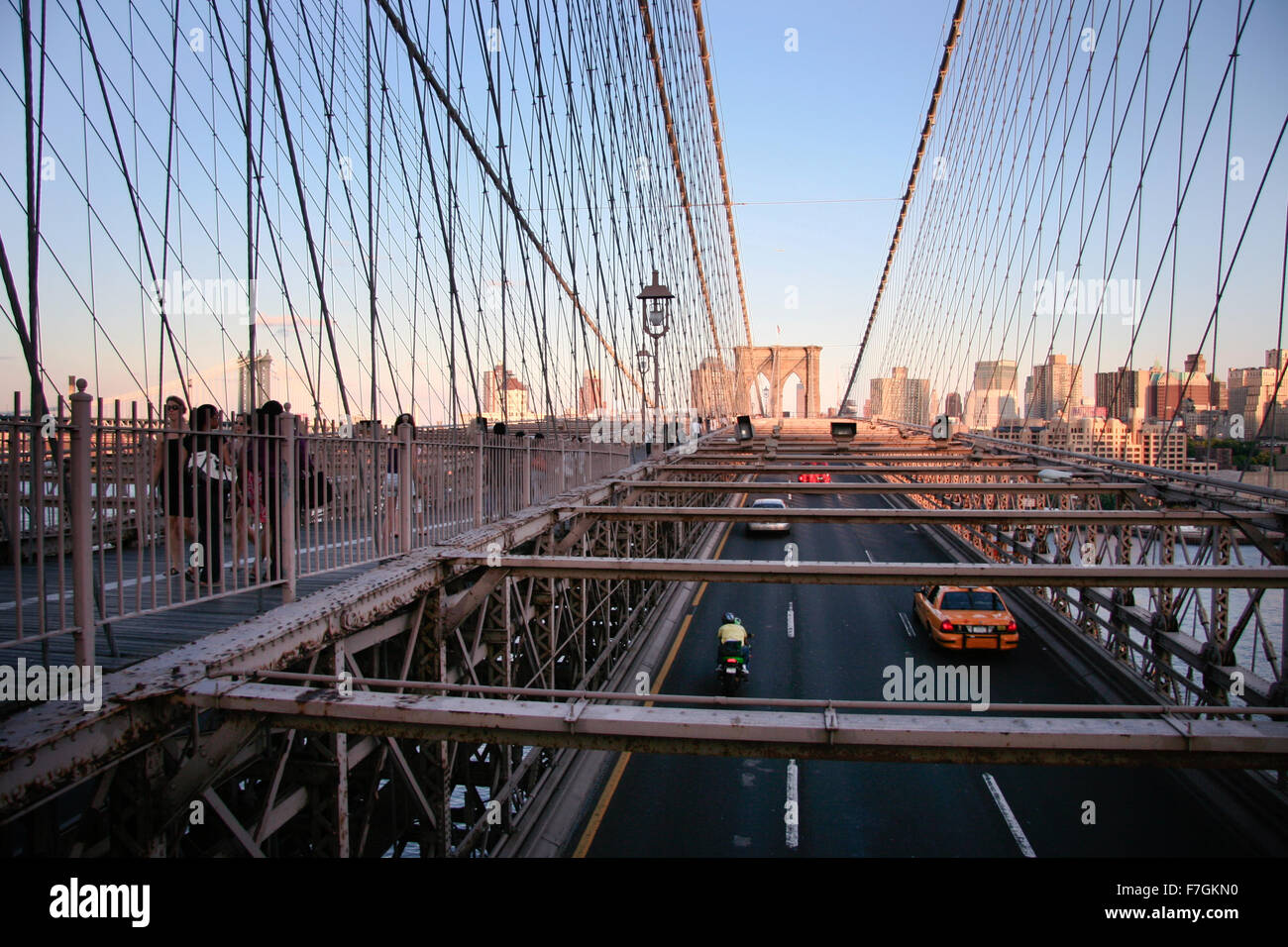 NEW YORK - JUN 25: Local people, tourists and cars on Brooklyn bridge ...