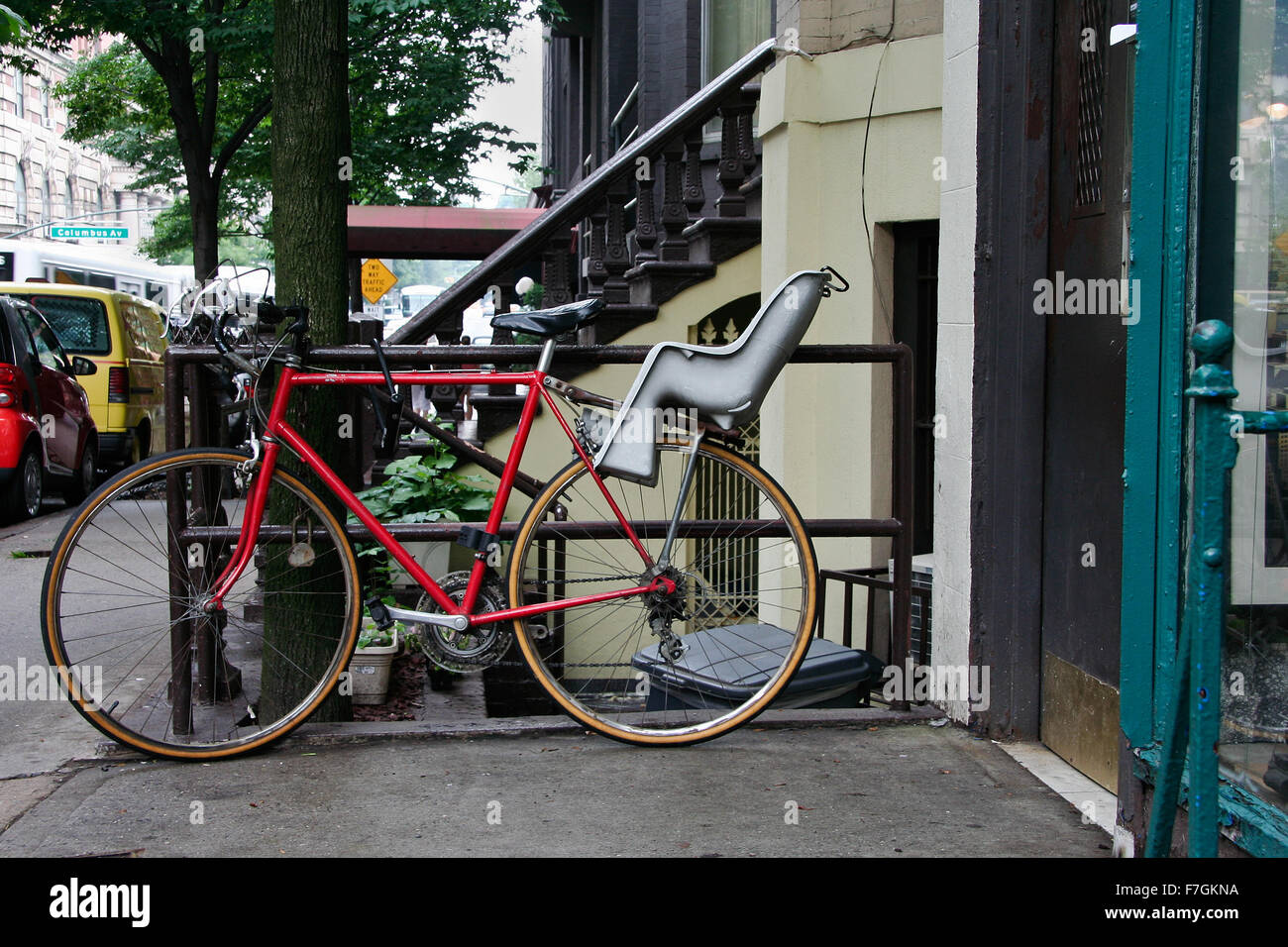 Red Bike with baby chair parked on one sidewalks of New York City Stock ...
