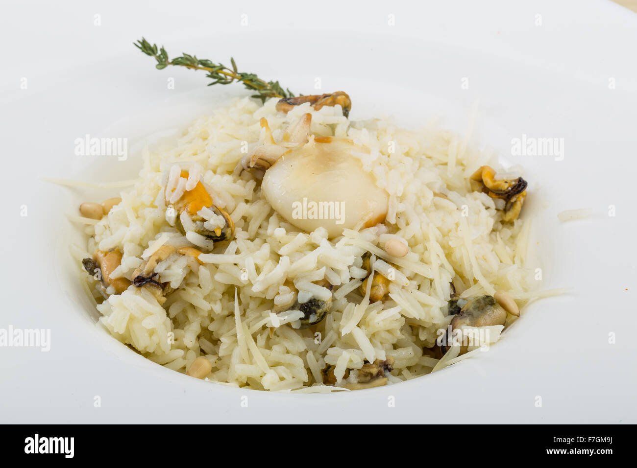 Risotto with mussels and cuttlefish served fresh thyme Stock Photo - Alamy