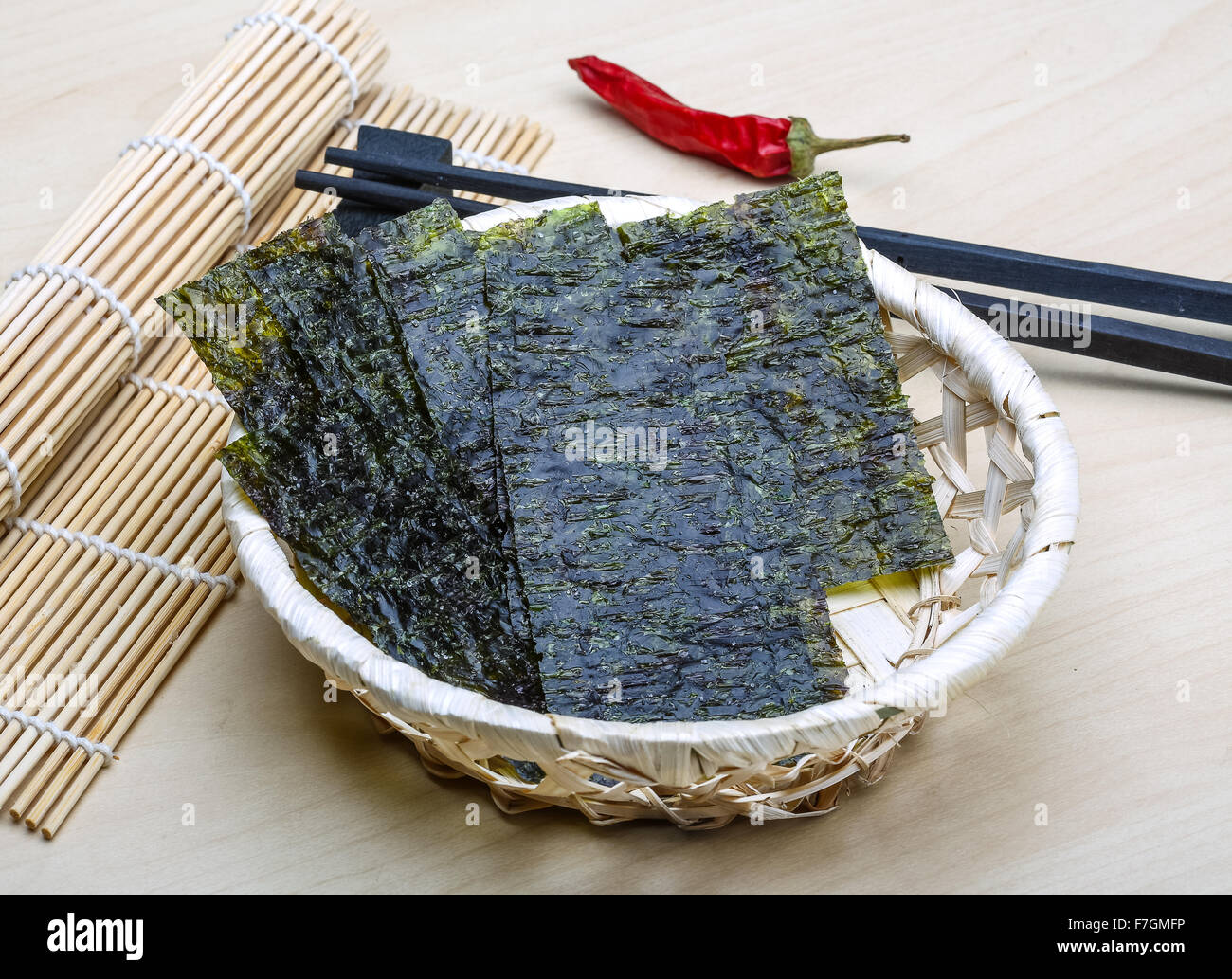 Nori sheets with sticks on the wood background Stock Photo - Alamy