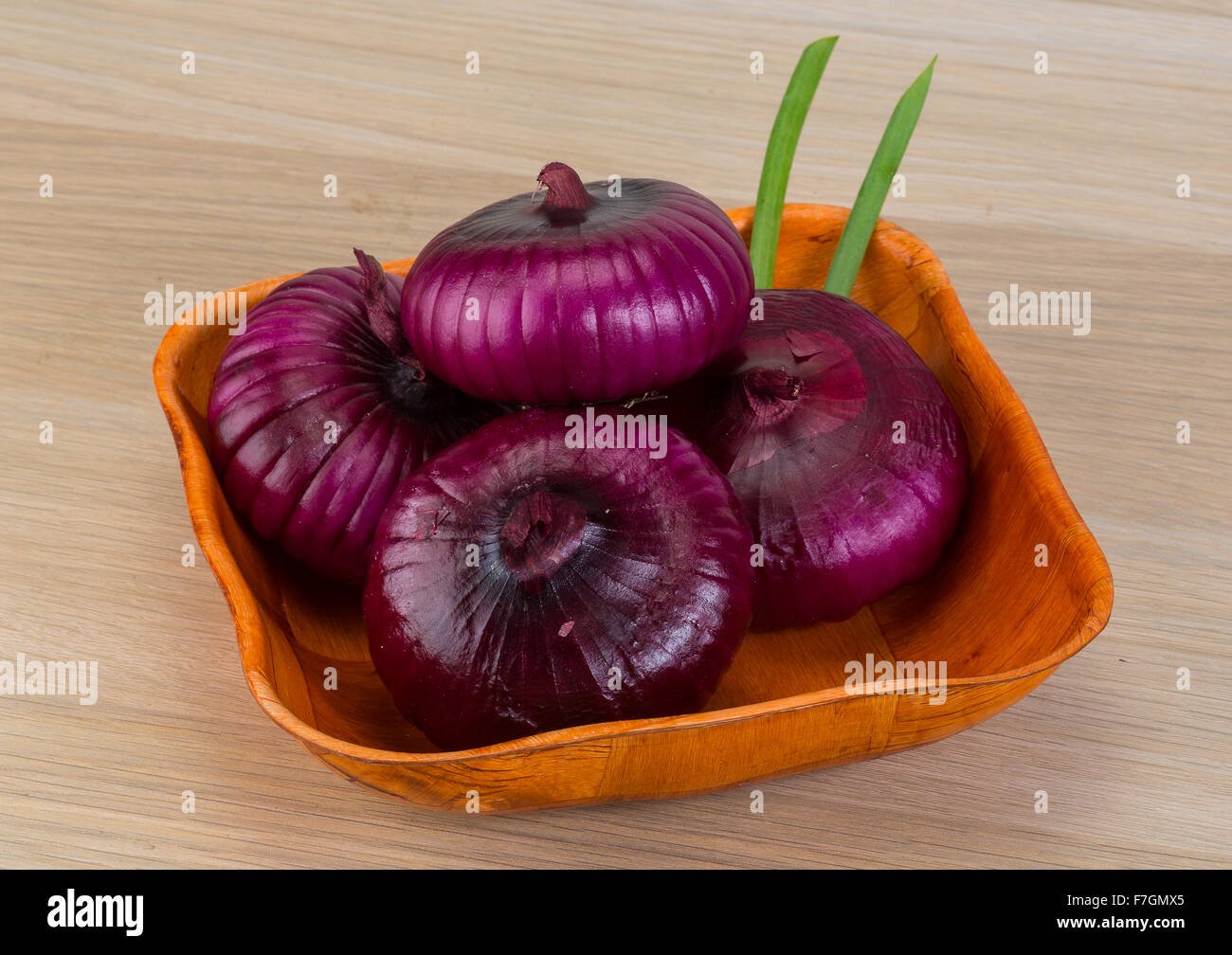 Violet onion in the basket with green Stock Photo - Alamy