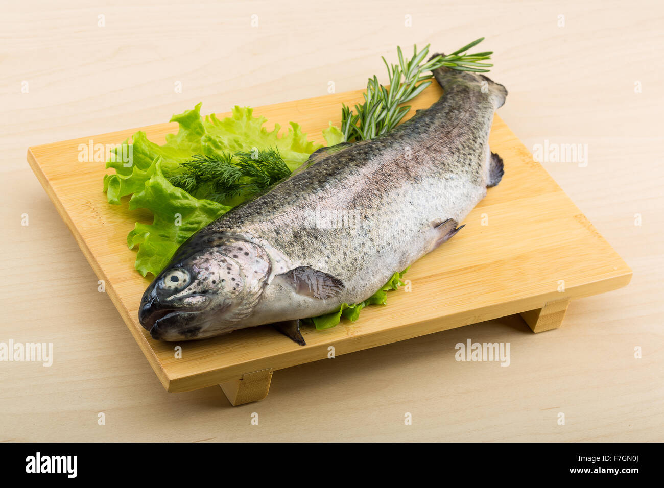 Raw fresh trout on the wood background with herbs Stock Photo - Alamy