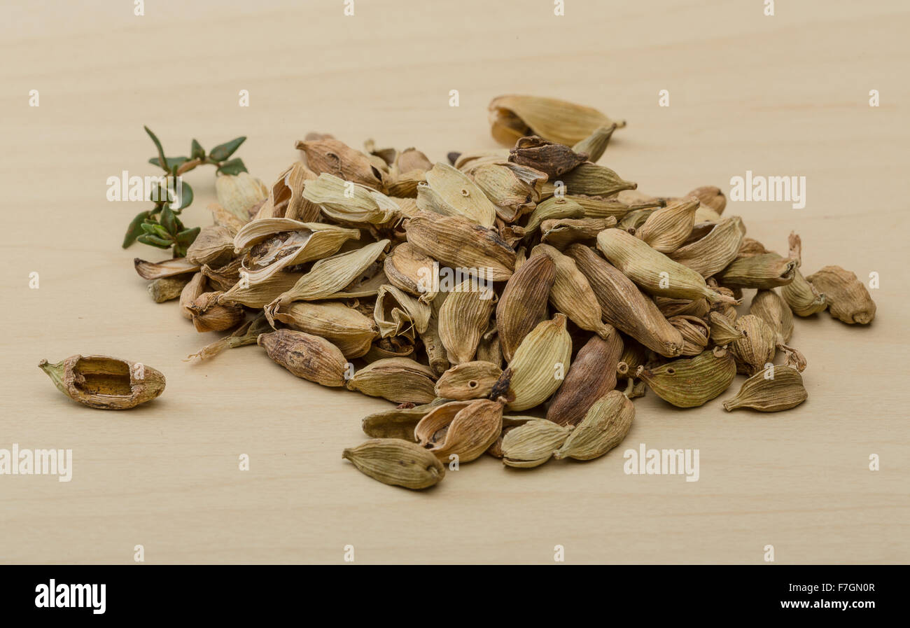 Dry Cardamom heap on the wood background Stock Photo - Alamy