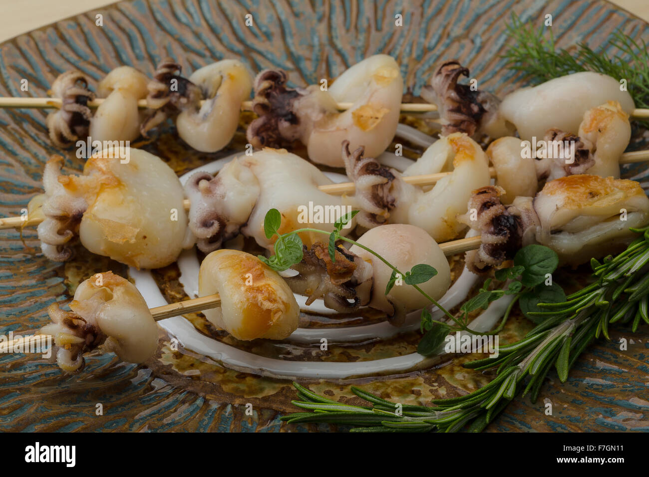 Grilled cuttlefish bbq with rosemary and pepper Stock Photo - Alamy
