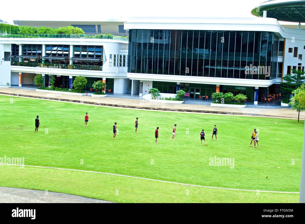 A group of students are playing in a university campus field Stock ...