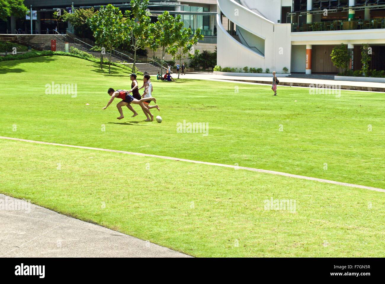 A group of students are playing in a university campus field Stock ...