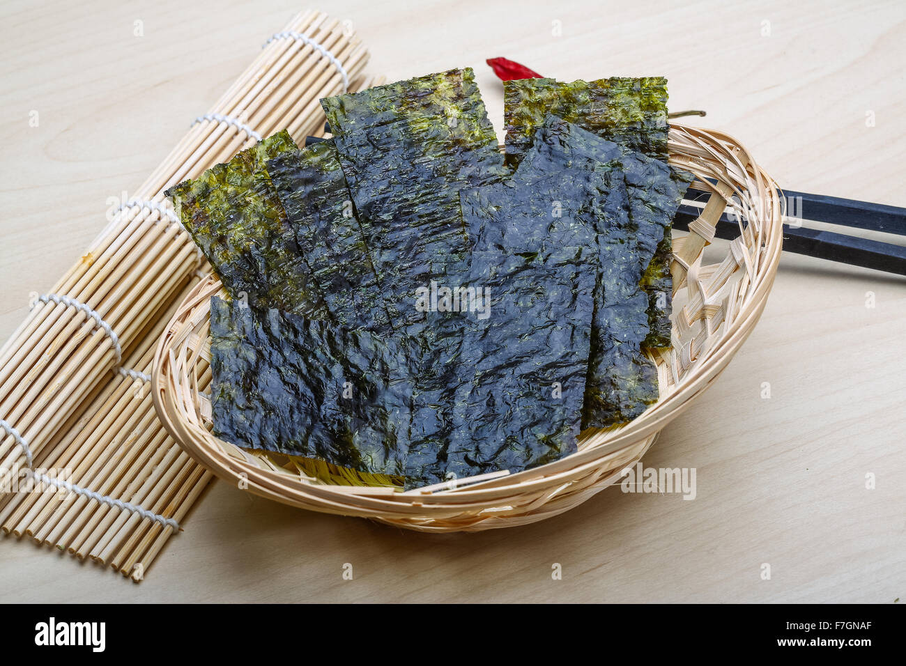 Nori sheets with sticks on the wood background Stock Photo - Alamy