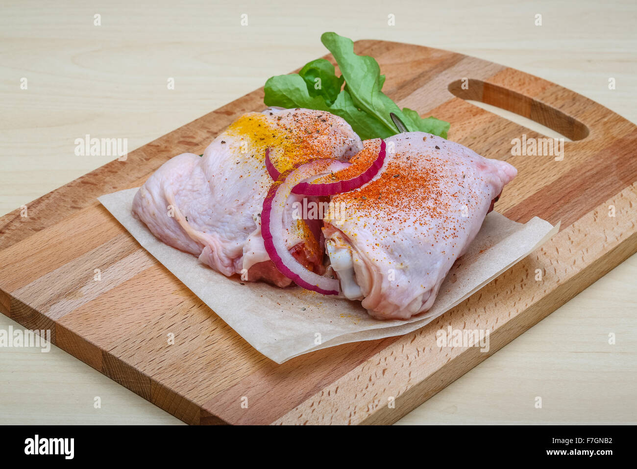 Two Raw chicken thights with herbs and spices Stock Photo - Alamy