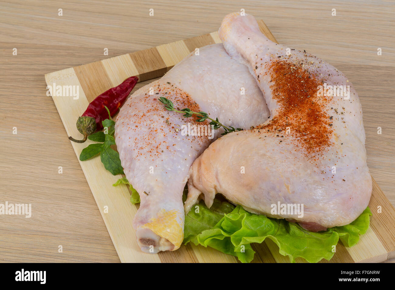 Raw chicken leg with herbs ready for cooking Stock Photo - Alamy