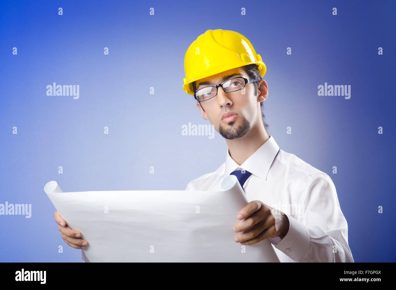 Young engineer looking at drawings Stock Photo - Alamy