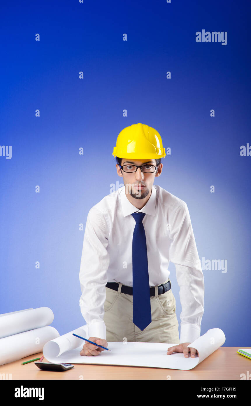Young engineer looking at drawings Stock Photo - Alamy