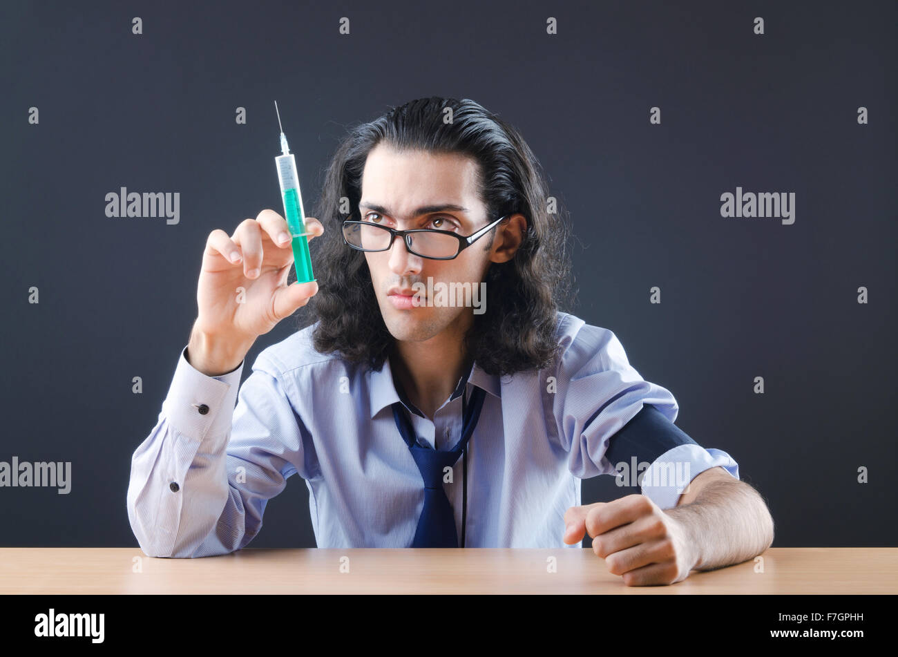 Young druc addict with syringe Stock Photo - Alamy